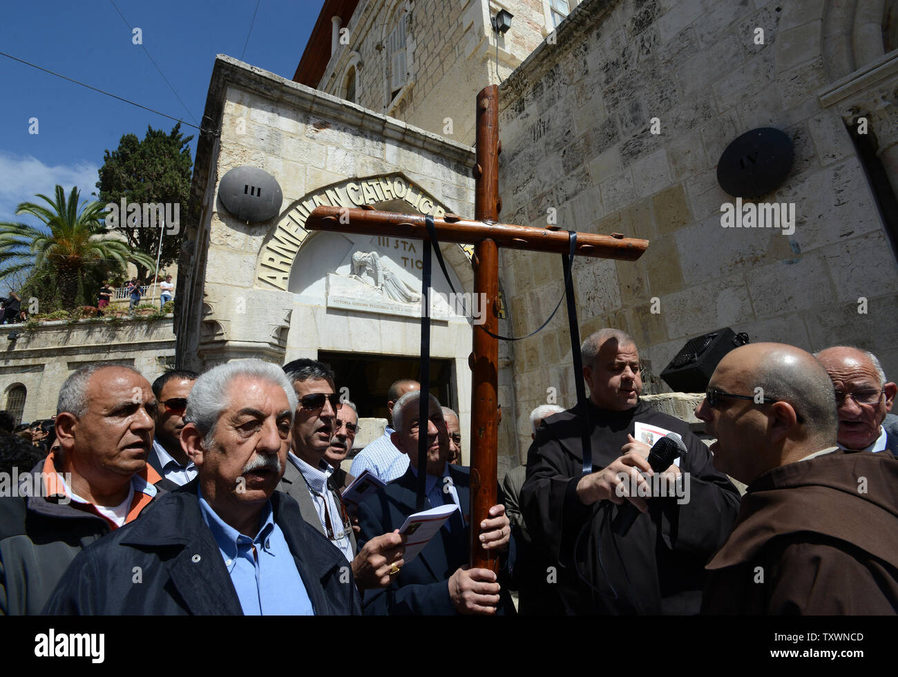 Palestinian Christians carry a cross on Good Friday on the Via Dolorosa ...
