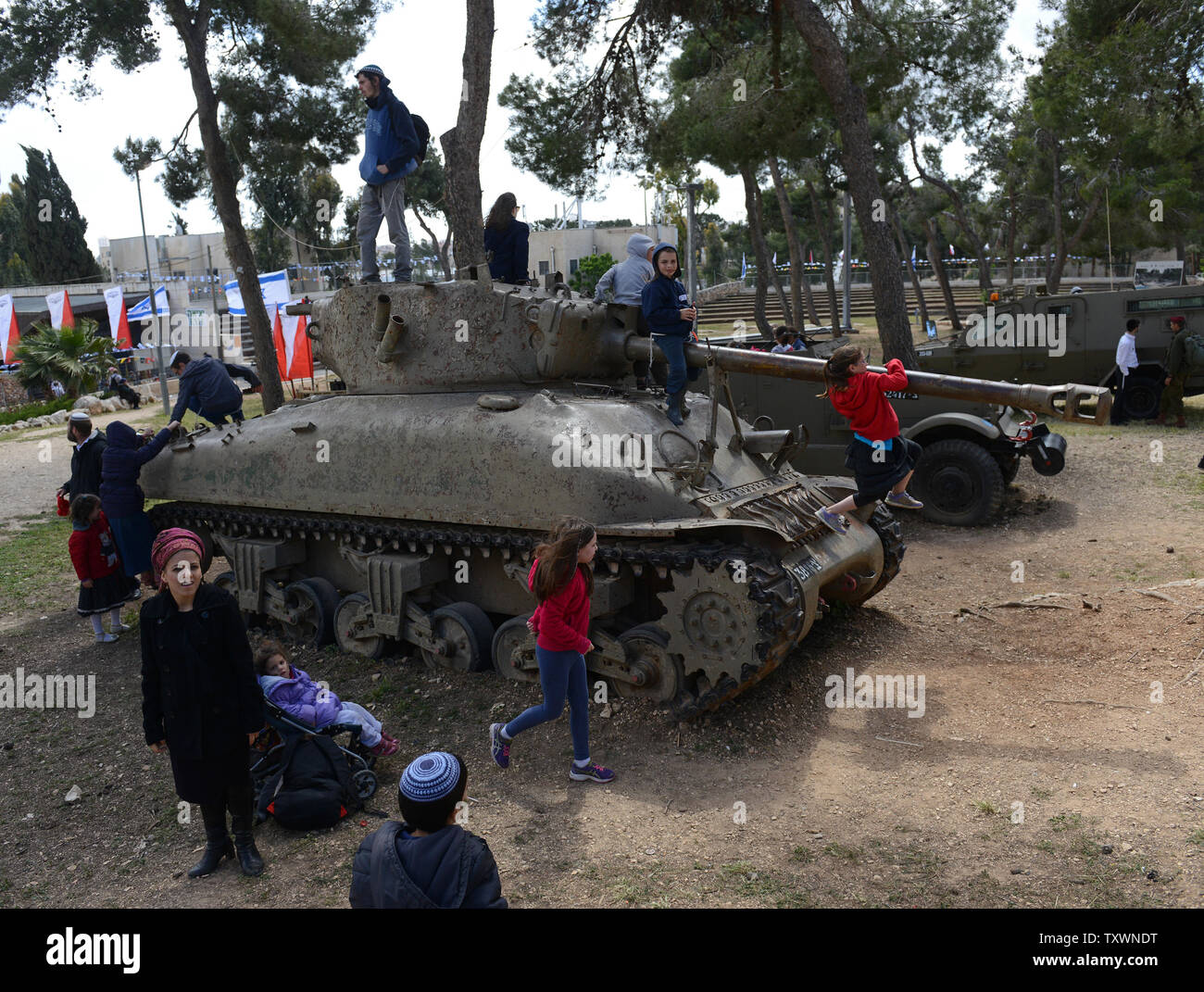 Israeli climb on top of a Sherman tank at an Israeli army exhibition ...