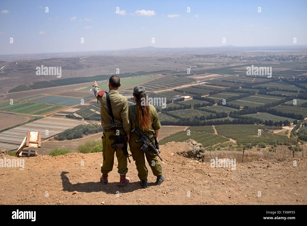 Israeli soldiers observe the Israeli-Syrian border from Mt. Bental ...