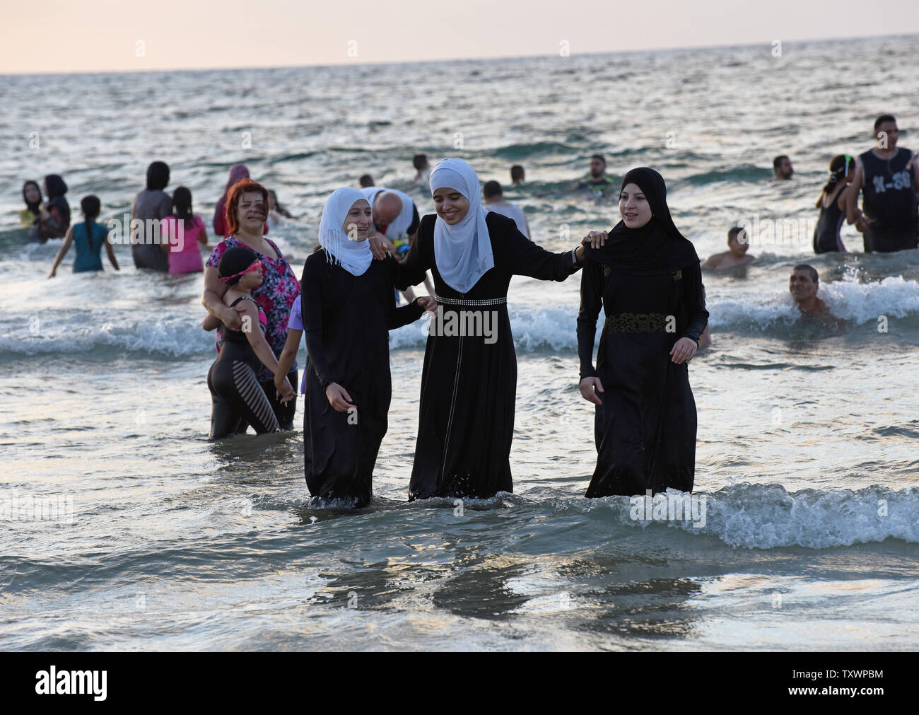 Muslim Palestinians stand in the Mediterranean Sea in Tel Aviv, Israel ...