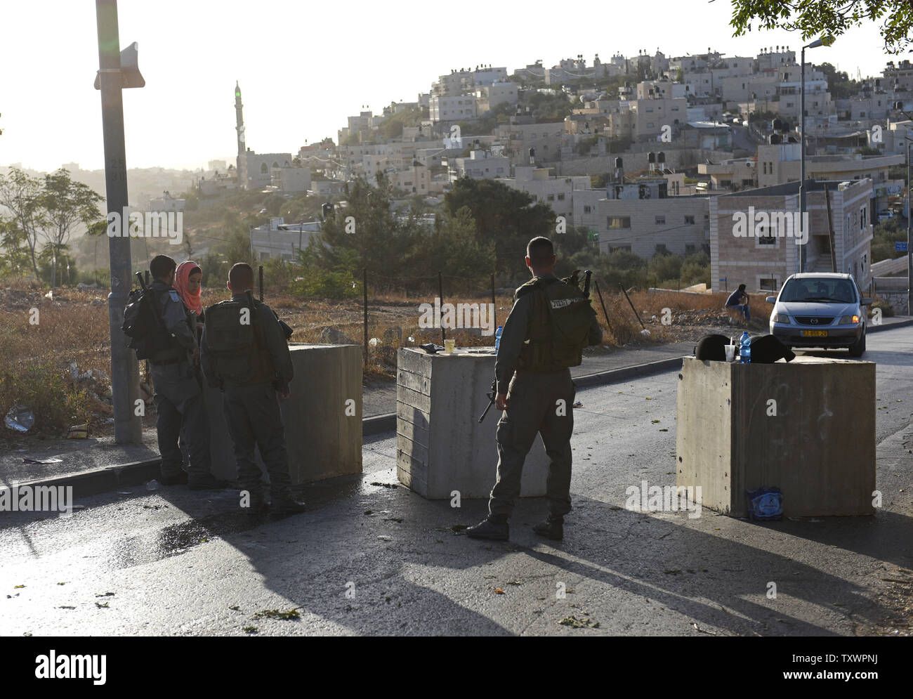 sraeli border police check a Palestinian's identity card at a newly ...