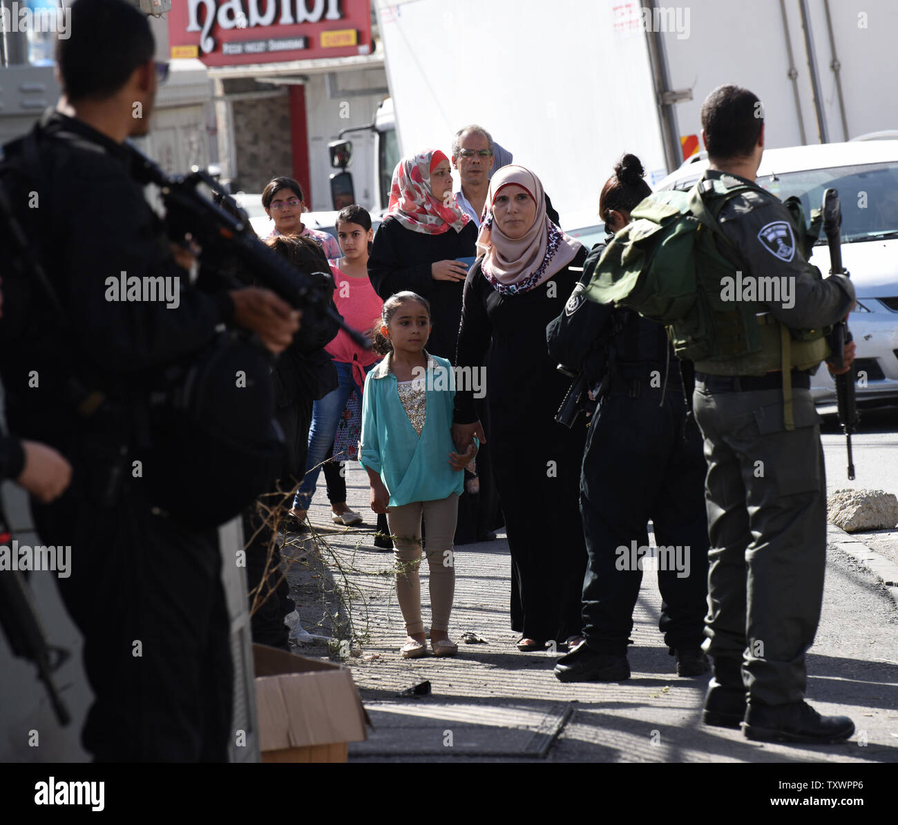 Israeli police check Palestinians identity cards next to newly ...