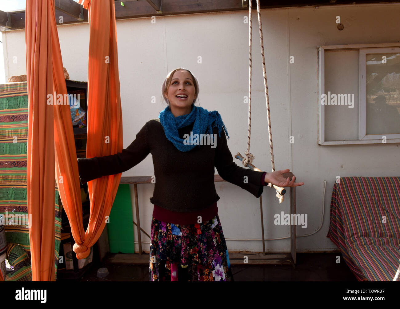 An Israeli settler stands outside her house in the Israeli illegal ...