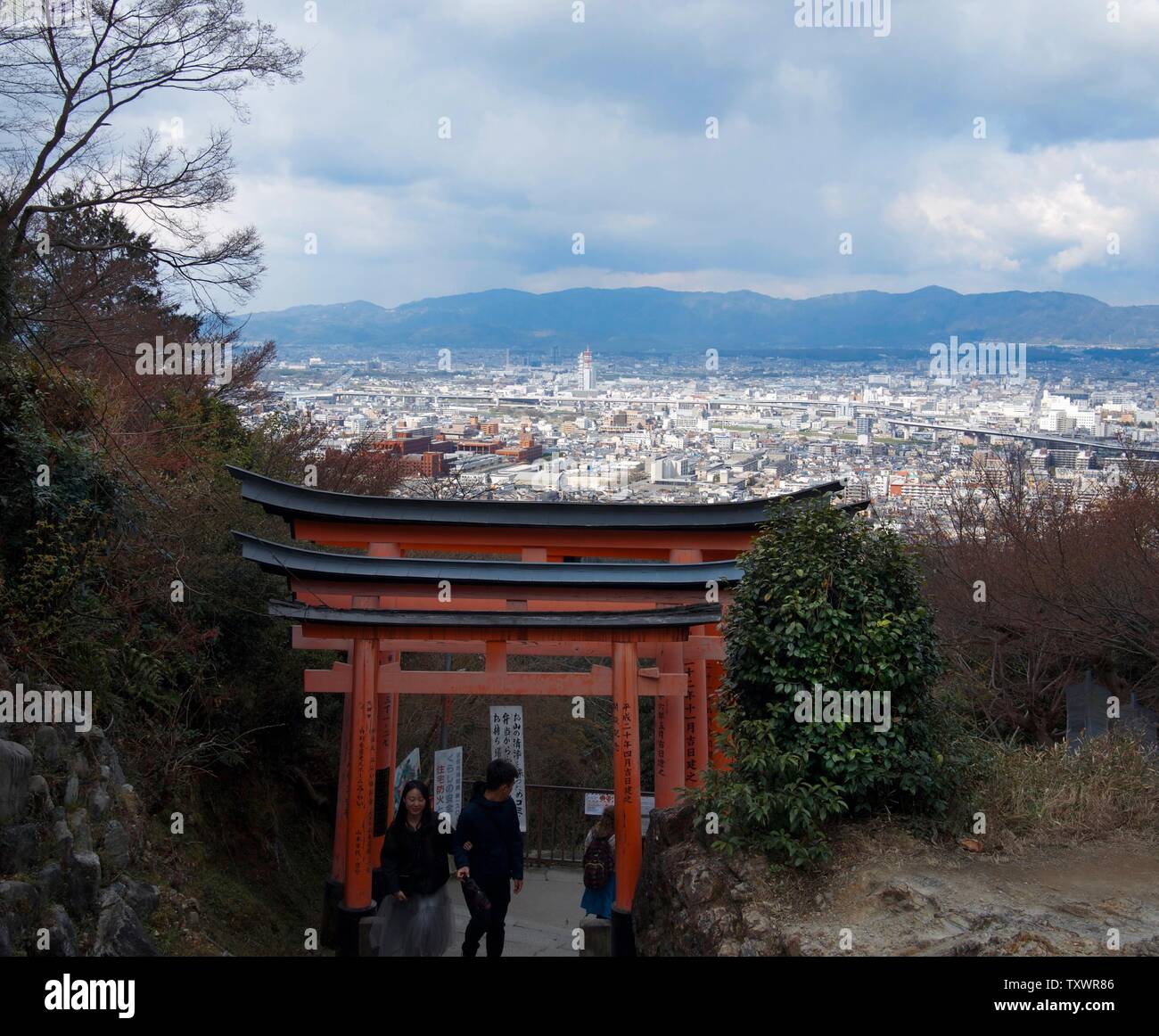 Red torii gates in Fushimi Inari Taisha Shrine and view of Kyoto from ...