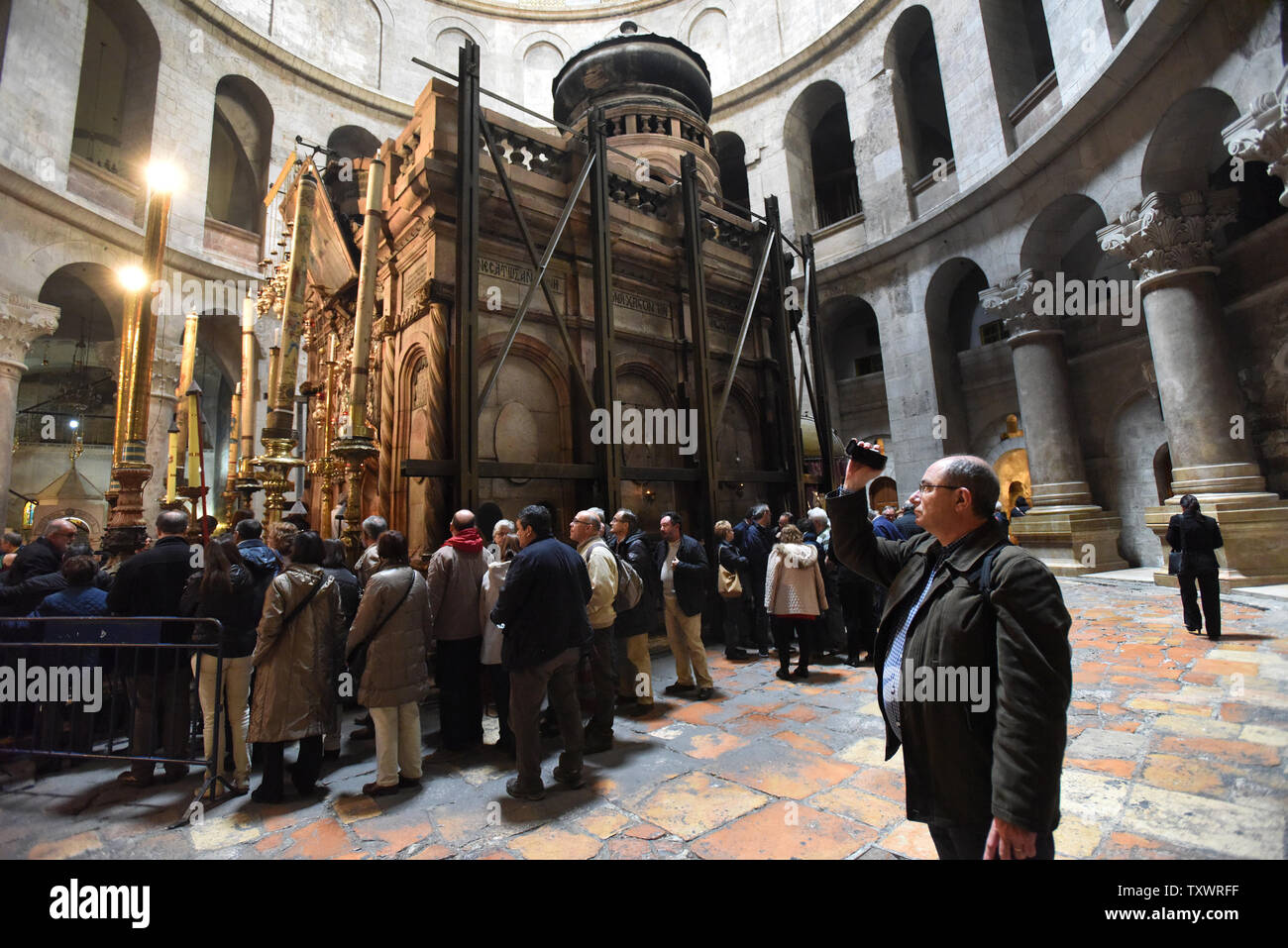 A tourist takes a photo in the Church of the Holy Sepulchre where it is ...