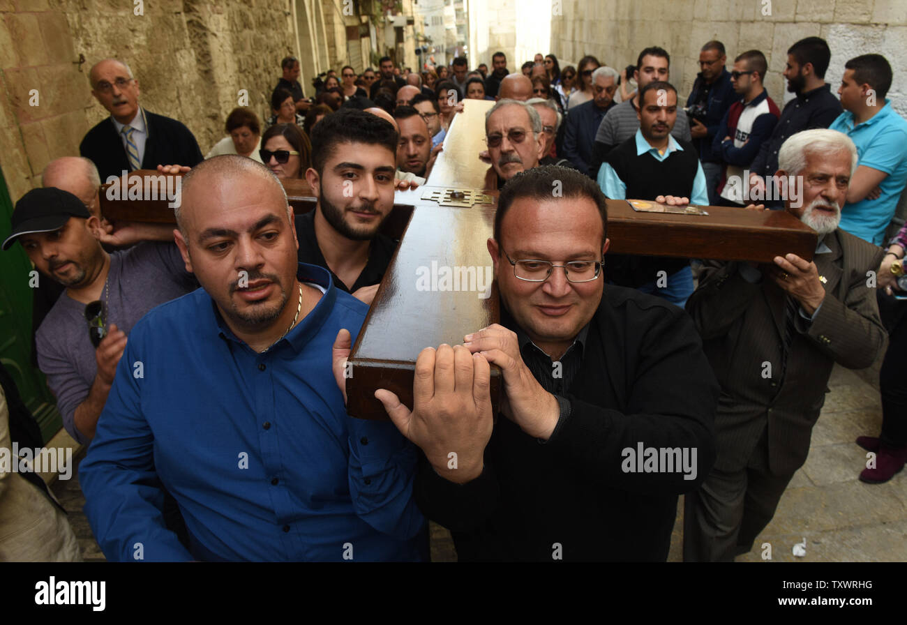 Palestinian Christians carry a cross on Good Friday on the Via Dolorosa ...
