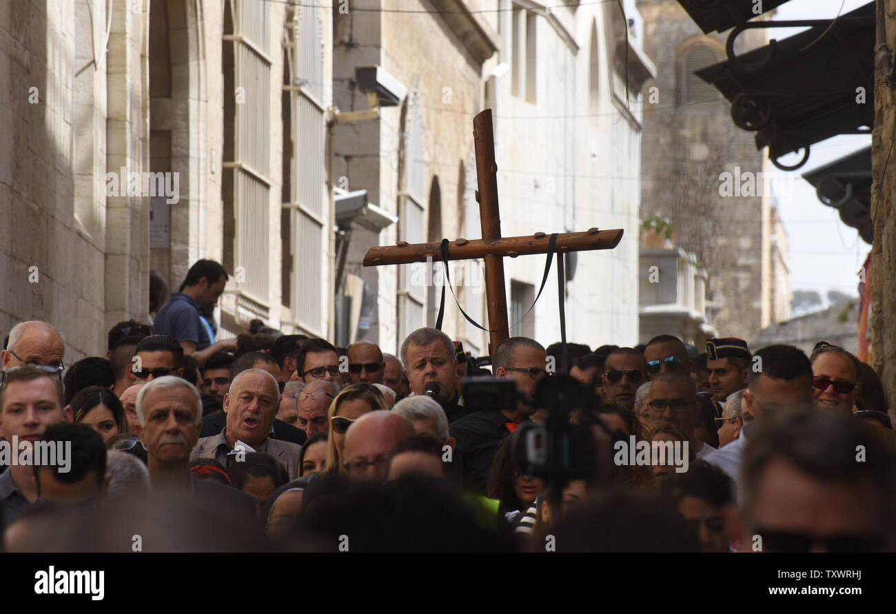 Palestinian Christians carry a cross on Good Friday on the Via Dolorosa ...