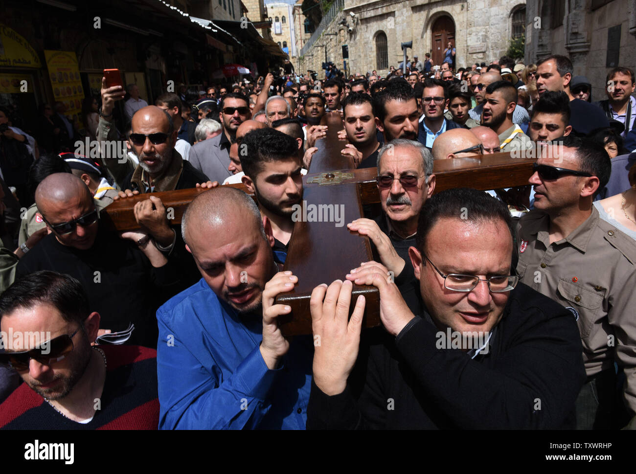 Palestinian Christians carry a large cross on Good Friday on the Via ...