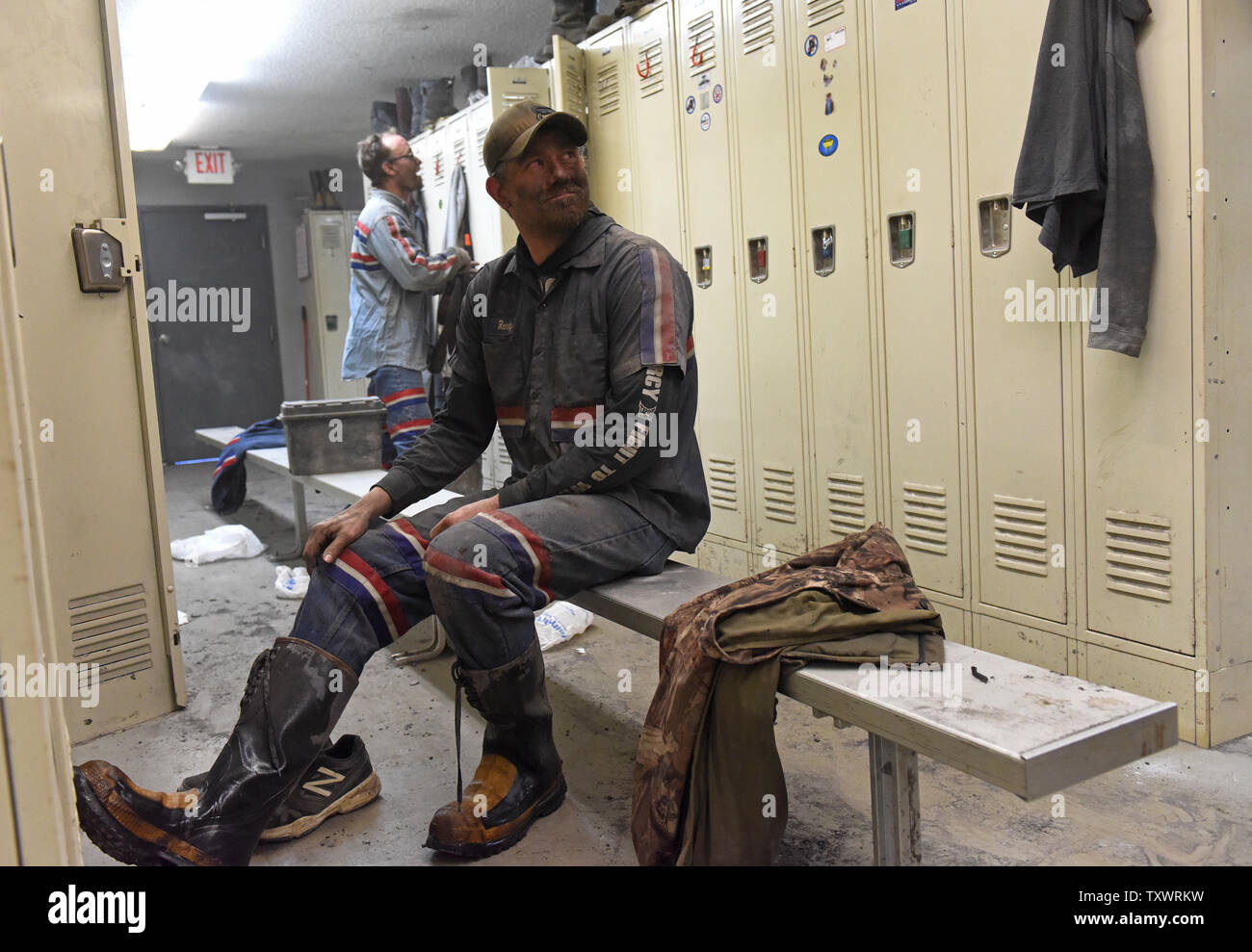 A miner sits in the locker room at the end of his shift in an ...