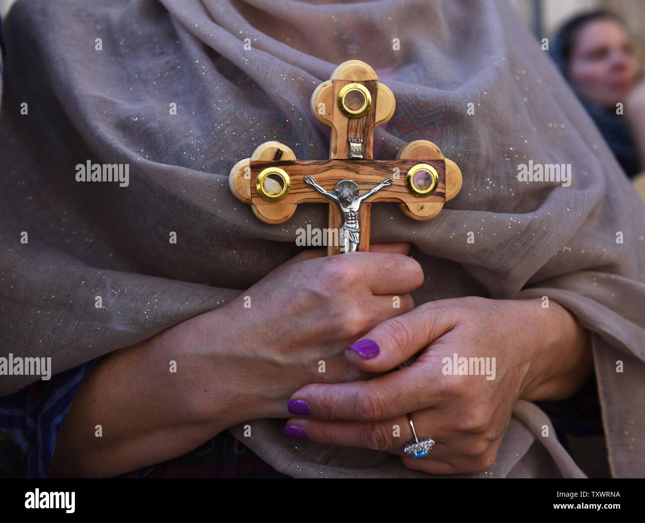 An Orthodox Christian woman holds a cross on the Via Dolorosa in the ...