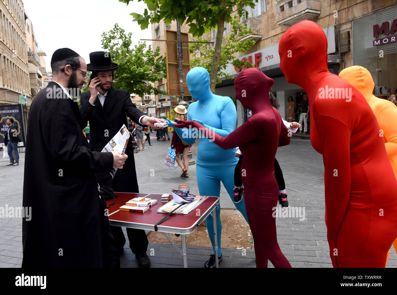 Members of the Israeli urban artist group "Prizma Ensemble" interact ...