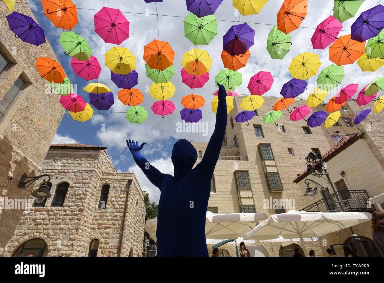 A member of the Israeli urban artist group "Prizma Ensemble" stands ...