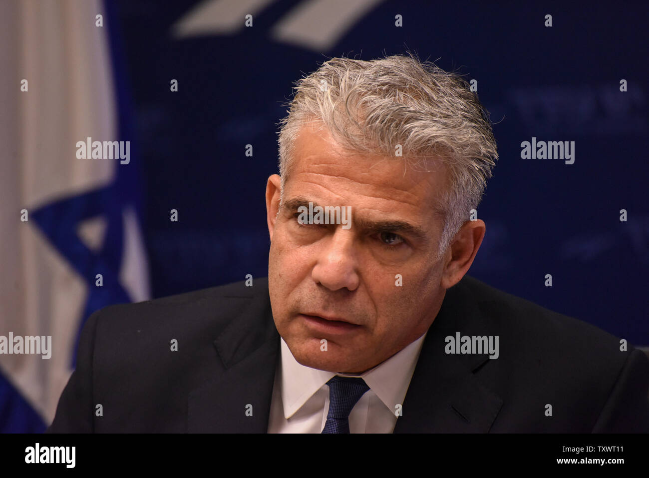 Knesset member, Yair Lapid peaks during the Yesh Atid Party meeting in ...