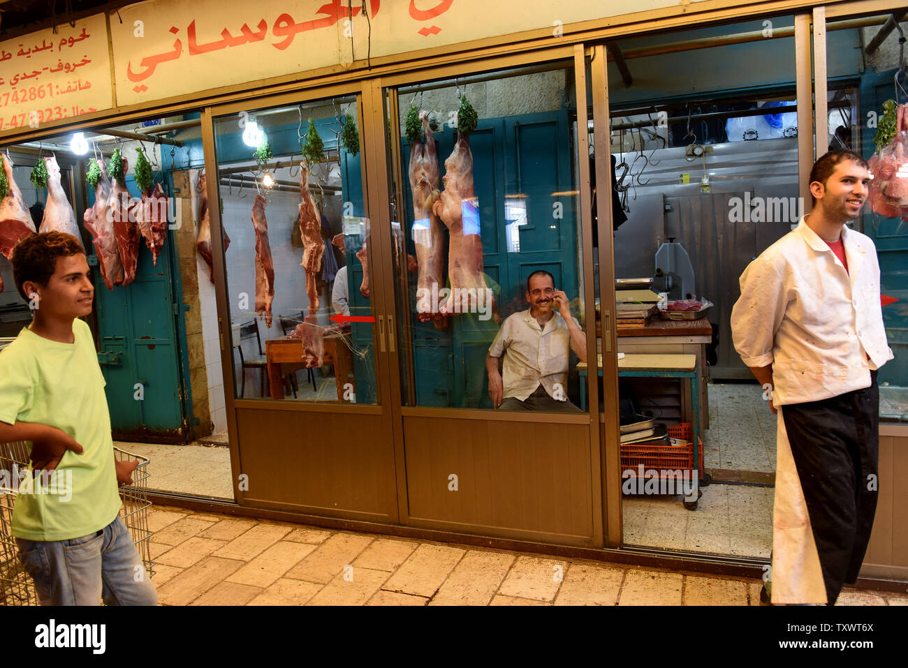 A Palestinian butcher waits for customers to buy lamb for the Muslim ...
