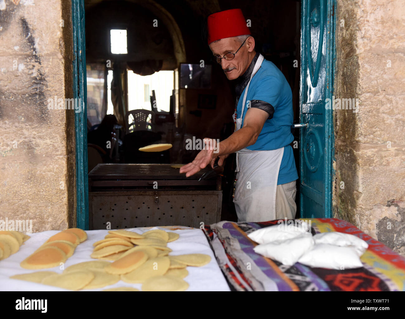 A Palestinian makes kataif for the Muslim festival of Eid al-Fitr, in ...