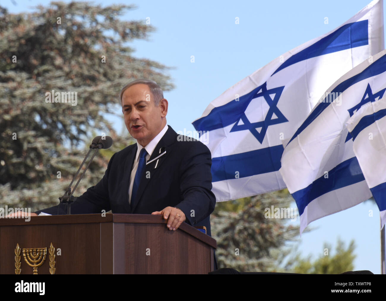 Israeli Prime Minister Benjamin Netanyahu speaks beside the coffin of ...