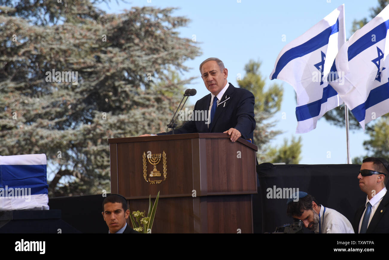 Israeli Prime Minister Benjamin Netanyahu speaks beside the coffin of ...