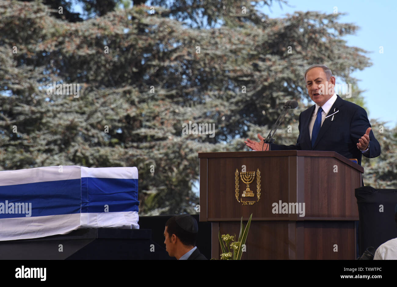 Israeli Prime Minister Benjamin Netanyahu speaks beside the coffin of ...