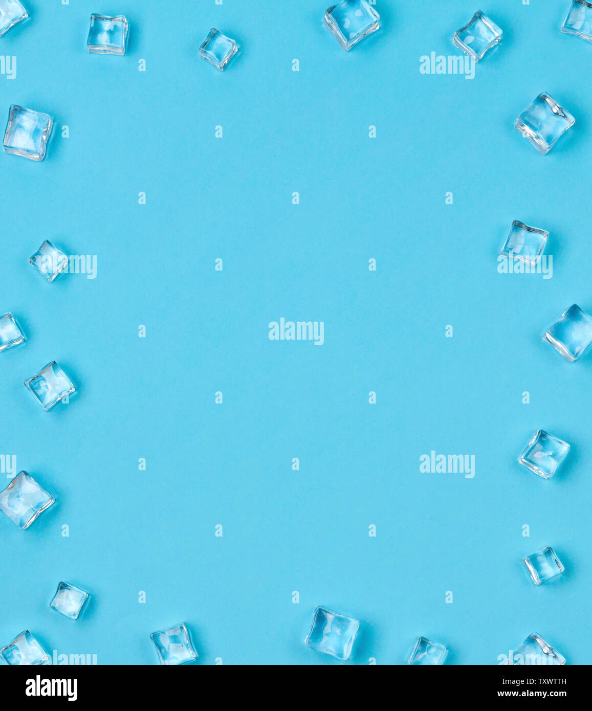 Ice cubes scattered on a light blue background Stock Photo - Alamy