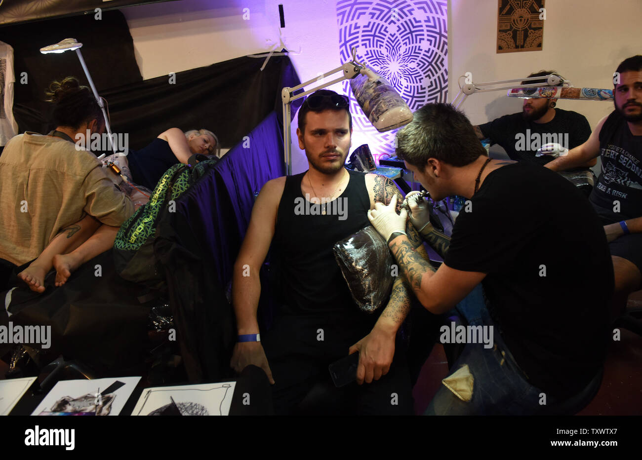 An Israeli gets a tattoo at the Israeli Tattoo Convention in Tel Aviv ...