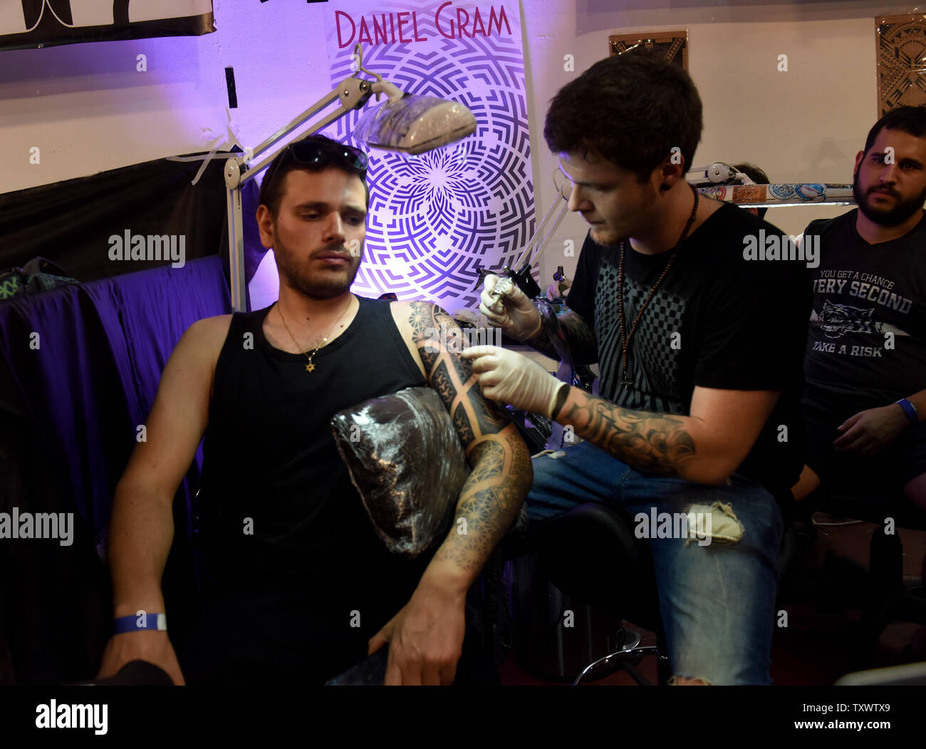 An Israeli gets a tattoo at the Israeli Tattoo Convention in Tel Aviv ...