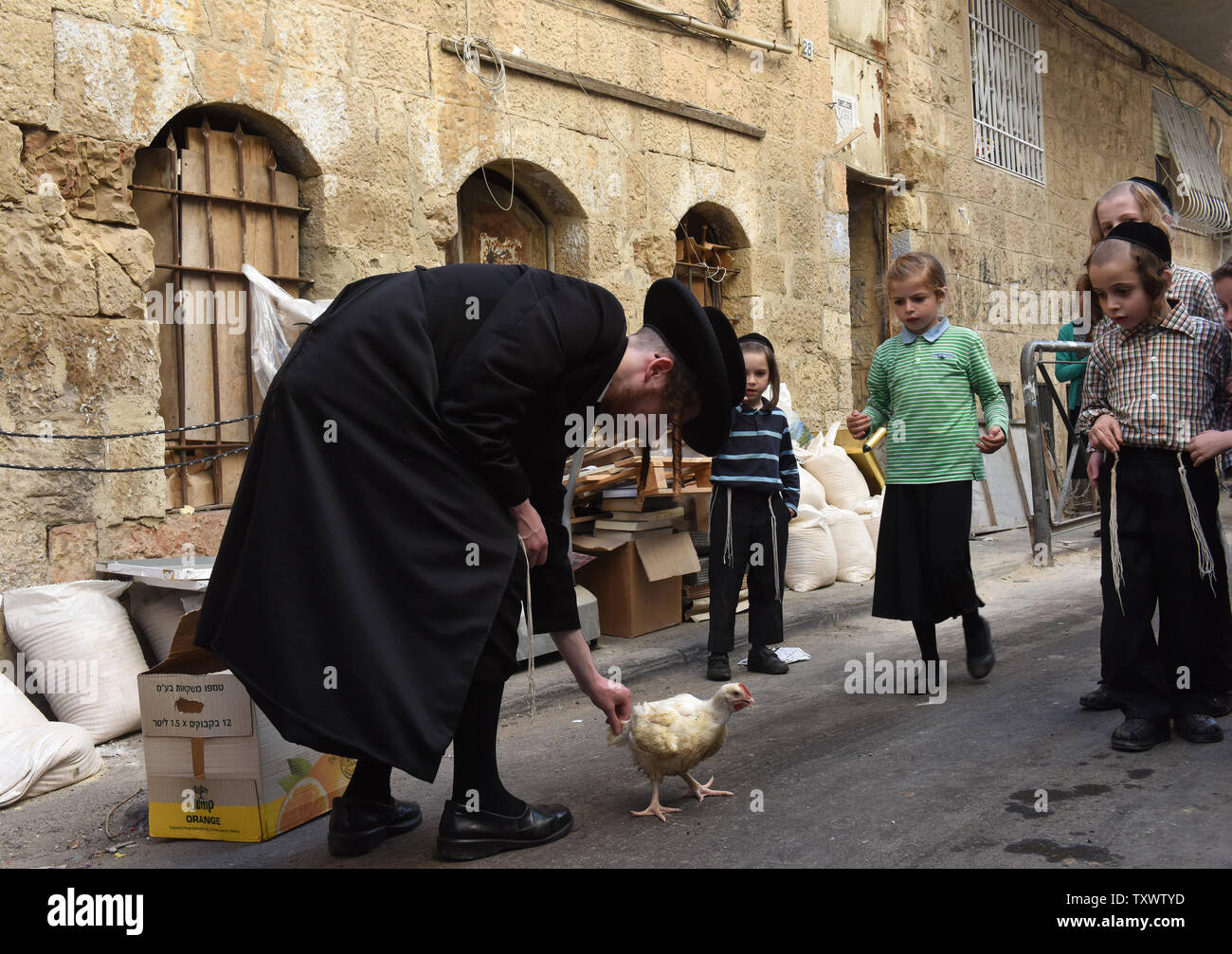 An Ultra-Orthodox Jewish man touches a chicken before he performs the ...