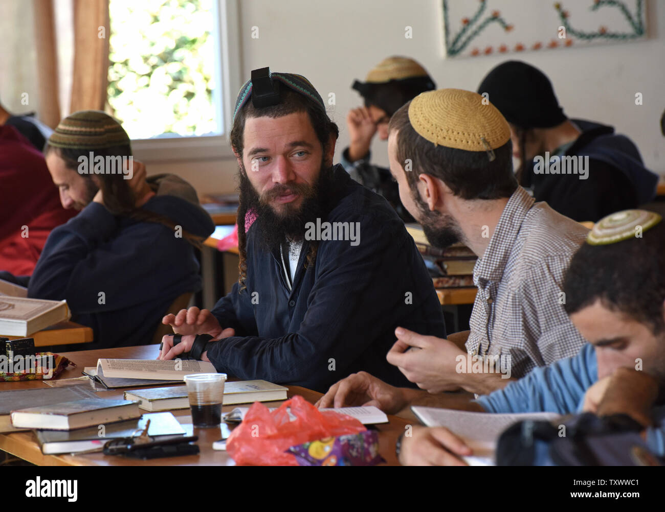 Jewish settlers study in a synagogue in the unauthorized Israeli ...