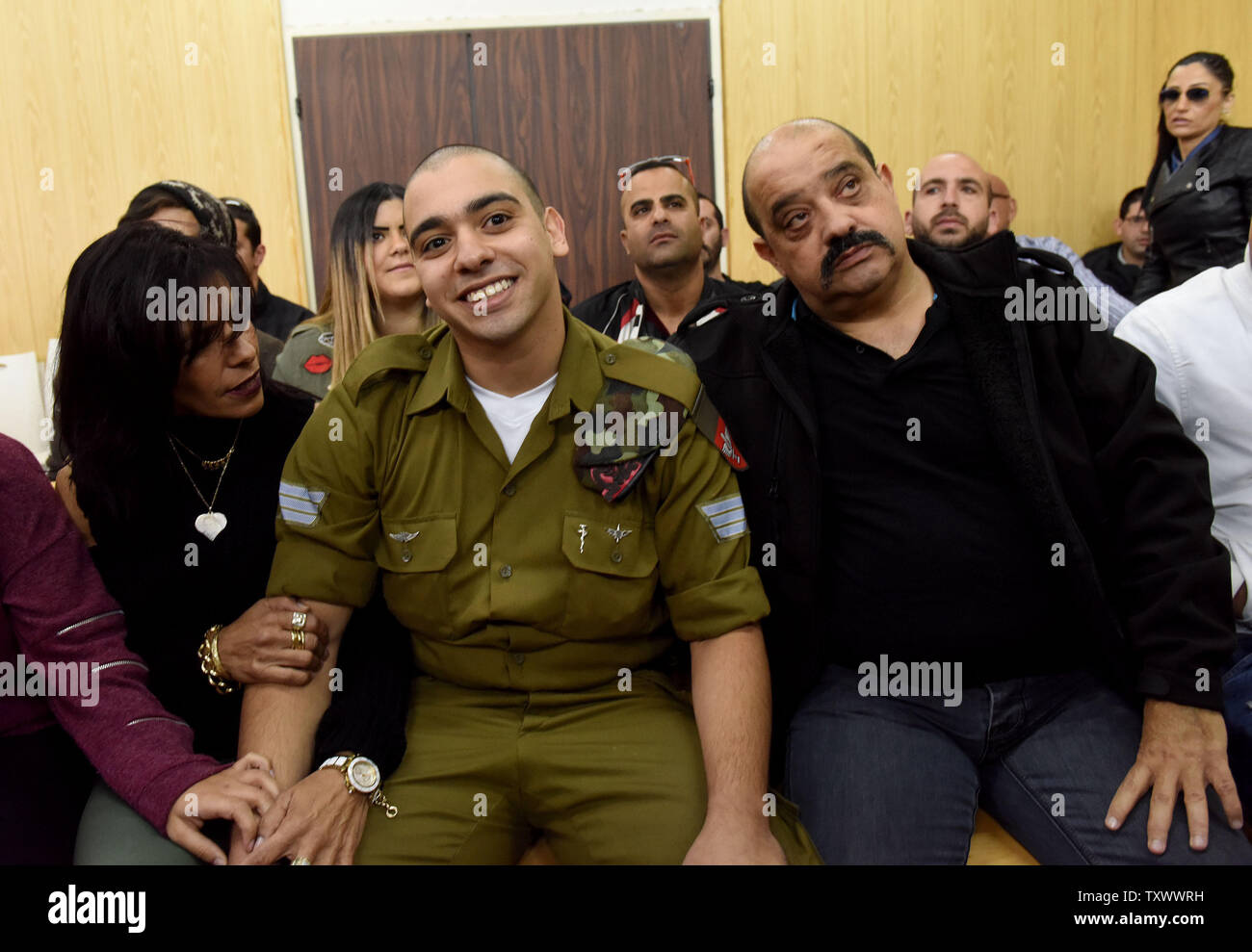 Israeli soldier Sgt. Elor Azaria sits with his family as he waits to ...