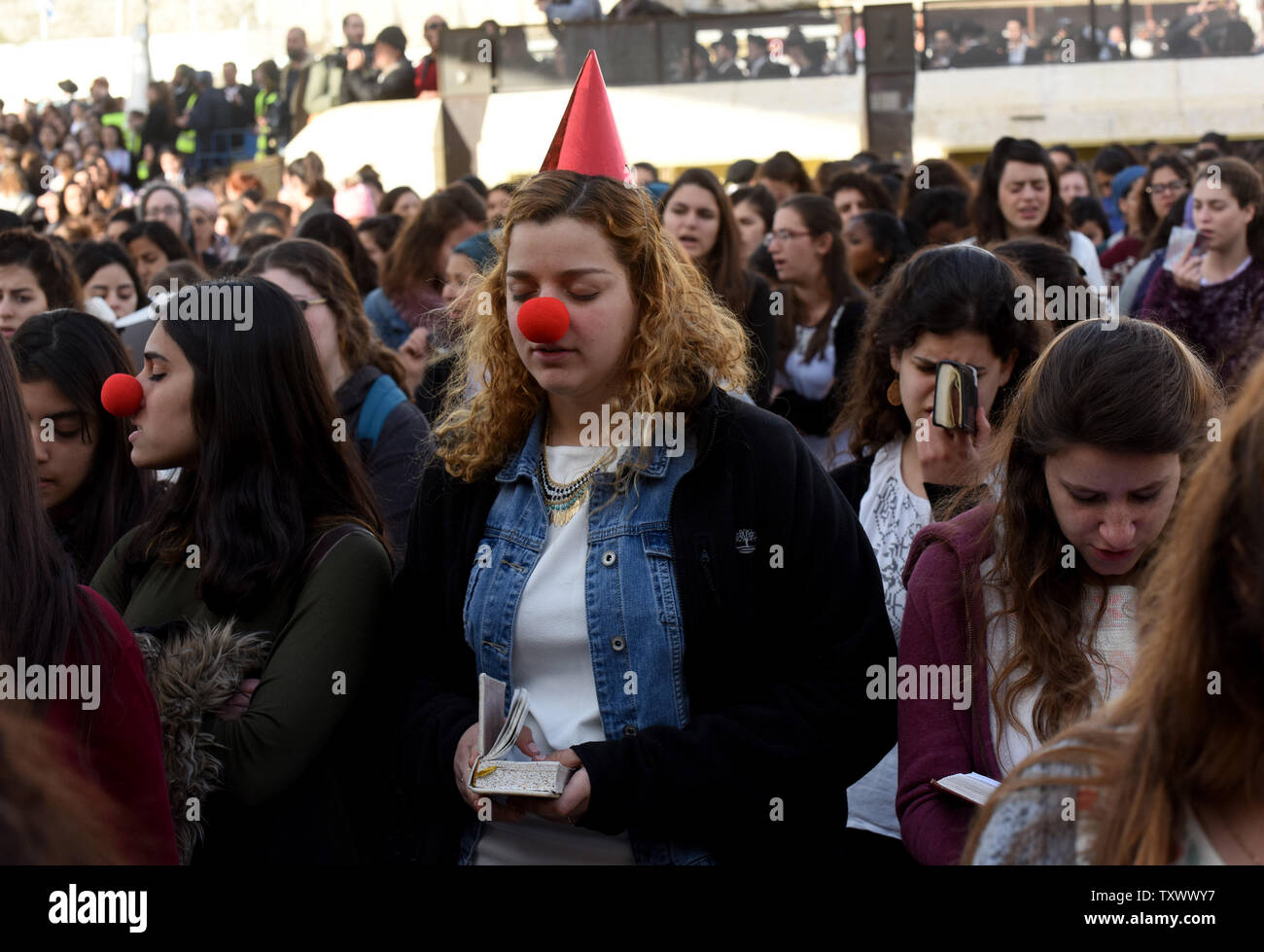 An Orthodox Jewish teen wears a Purim costume at the morning service at ...