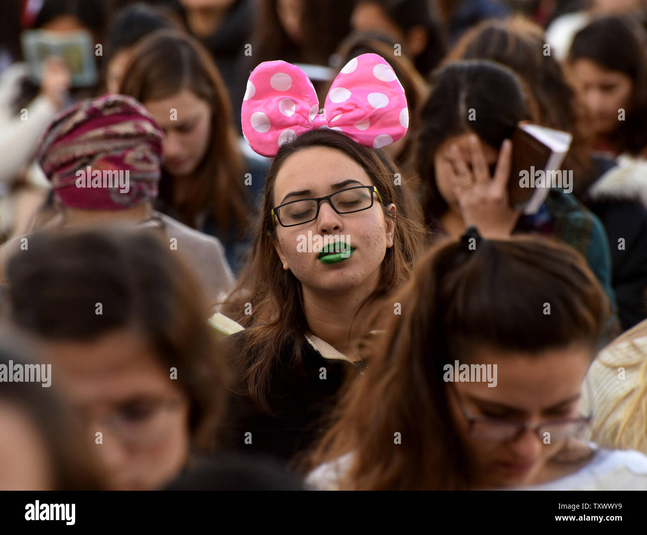 An Orthodox Jewish teen wears a Purim costume at the morning service at ...