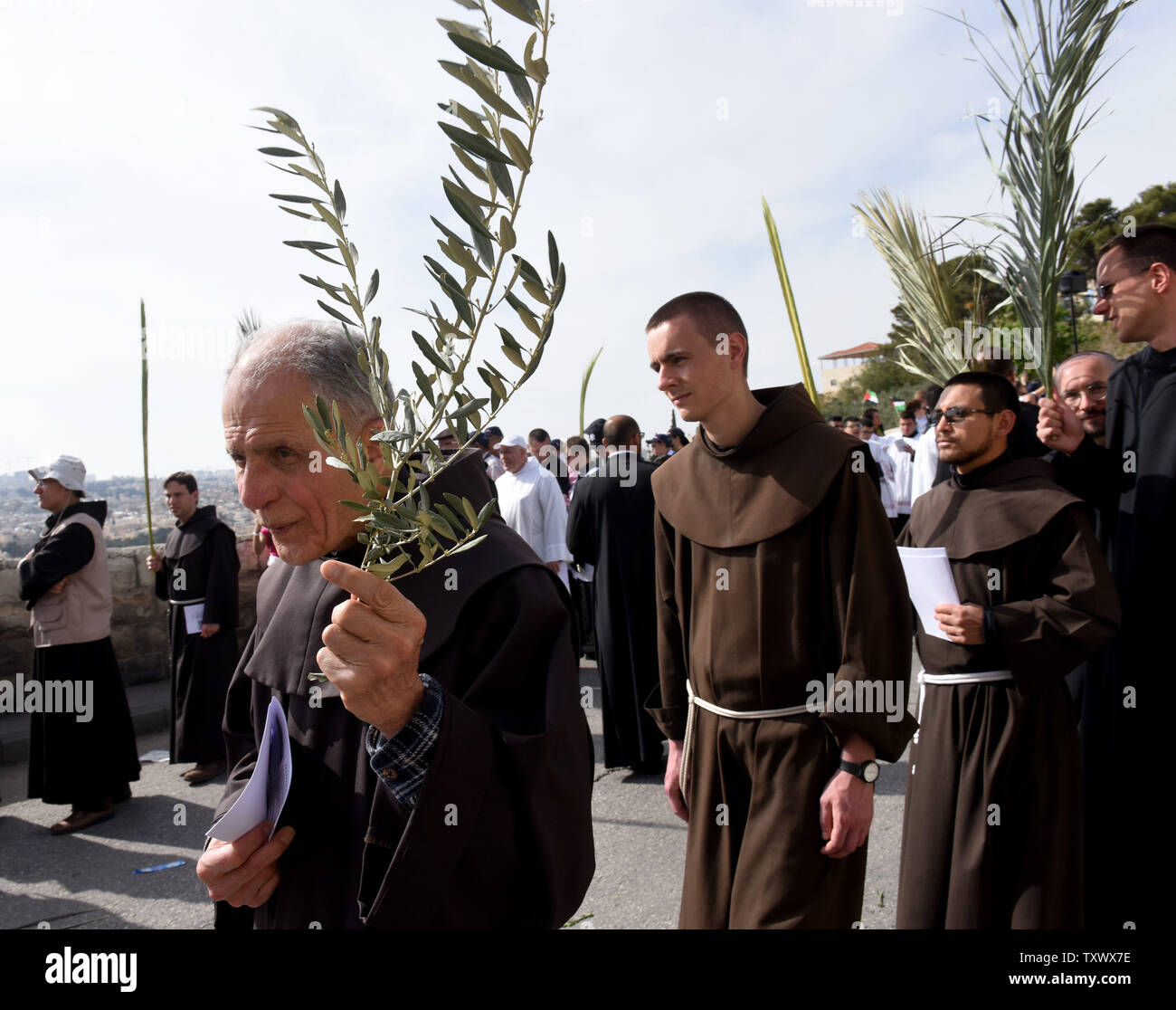 Catholic priests carry olive branches during the annual Palm Sunday ...