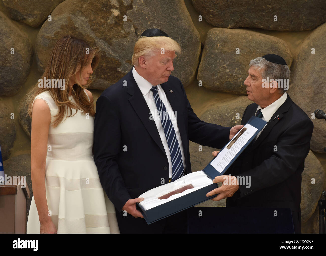 U.S. President Donald Trump and his wife Melania receive a gift of a ...