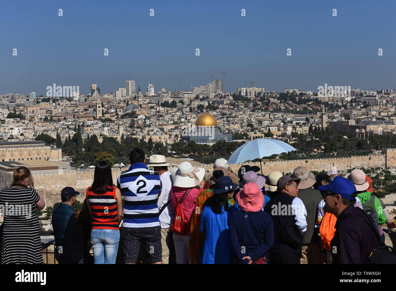 Tourists stand on the Mt. of Olives overlooking the Al-Aqsa Mosque ...
