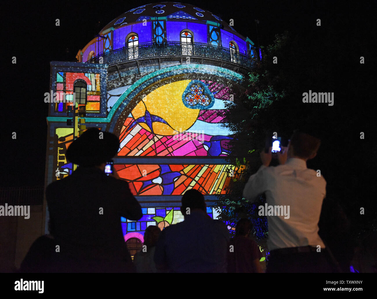 Visitors enjoy a light art installation projected on the Hurva ...