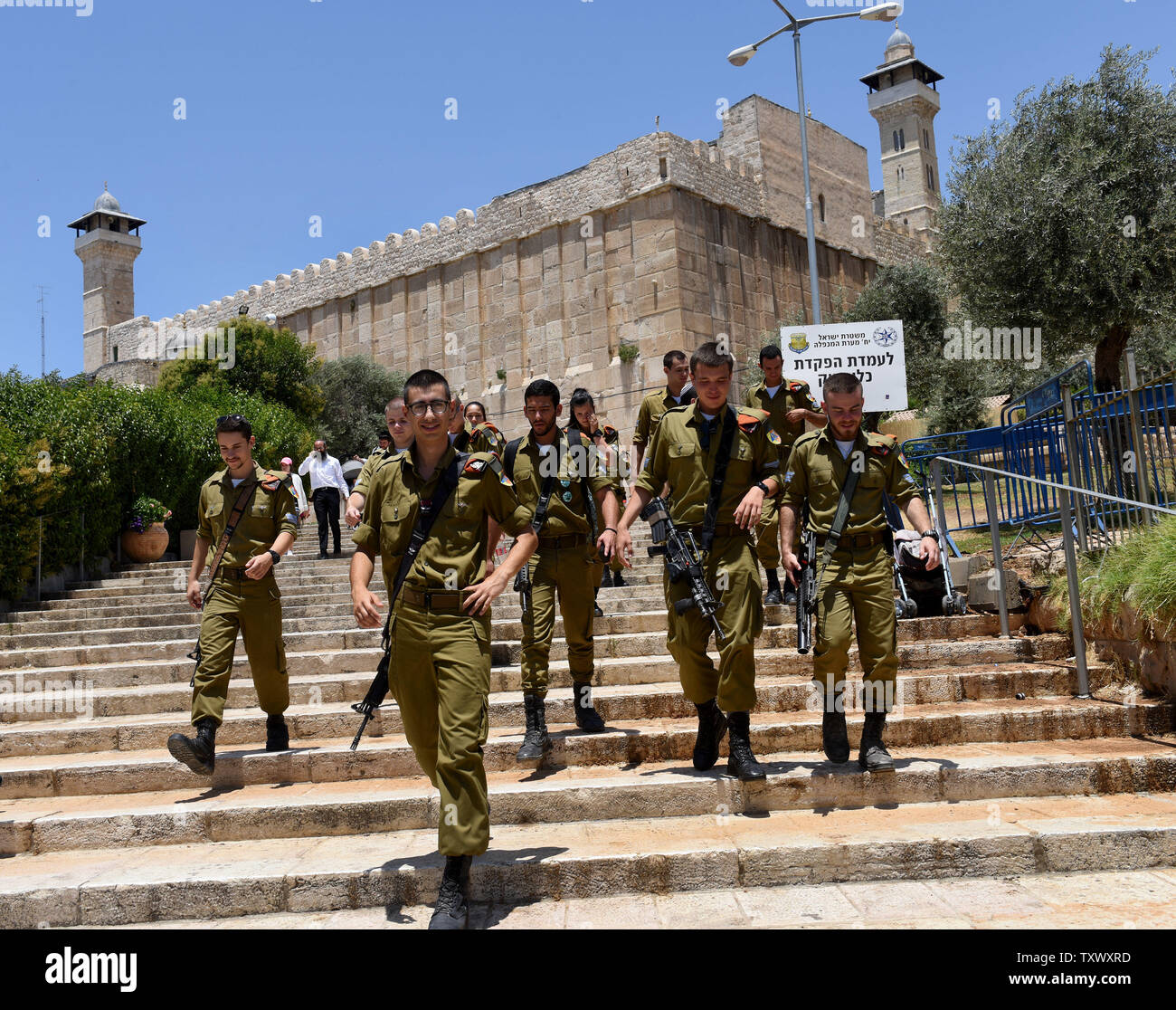 Israeli soldiers descend the stairs to the Cave of the Patriarchs, also ...