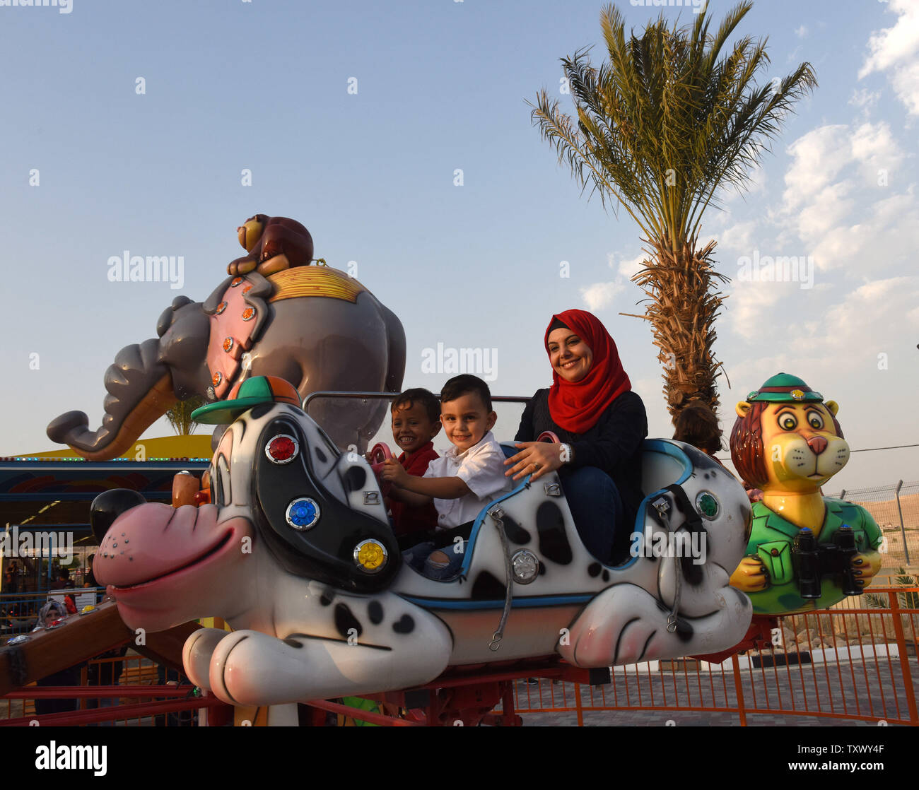 Palestinians enjoy rides on the third day of the Muslim feast of Eid al ...