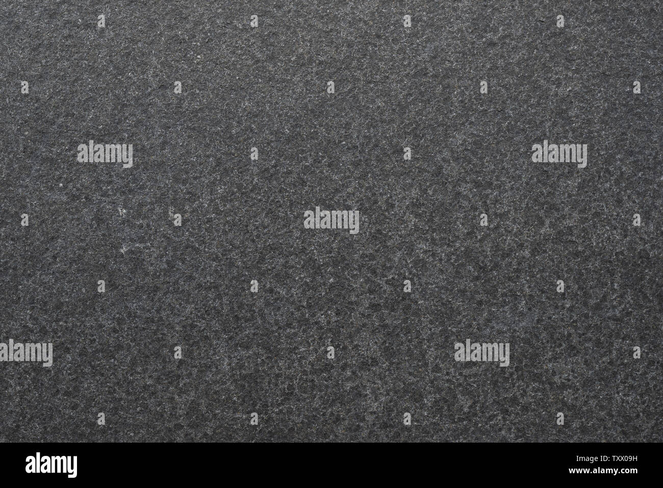 Dark granite. The texture of natural stone slabs for facing the facade ...