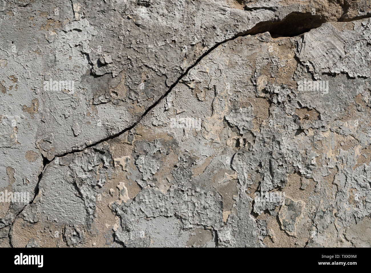 Old textured concrete wall with traces of putty, peeling paint and ...