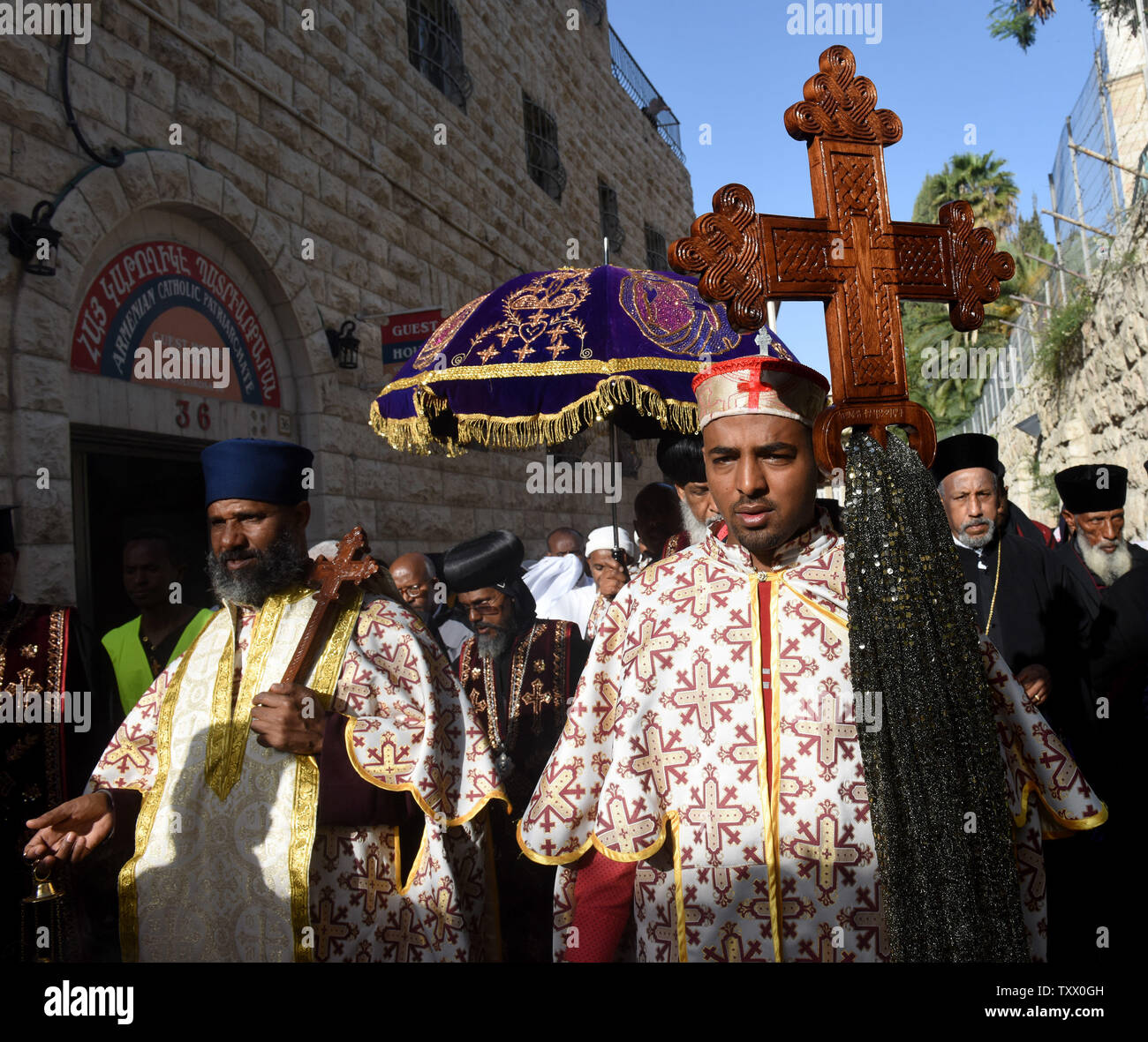 An Ethiopian Orthodox Christian carries a large wooden cross during the ...