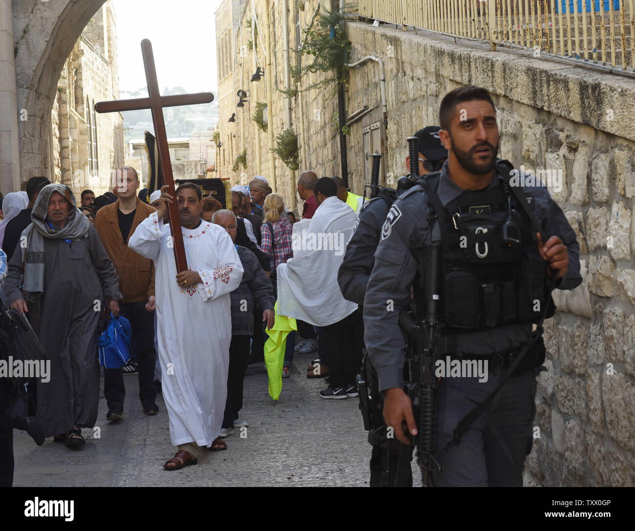 Coptic Orthodox Christians, from Egypt, carry a large wooden cross ...