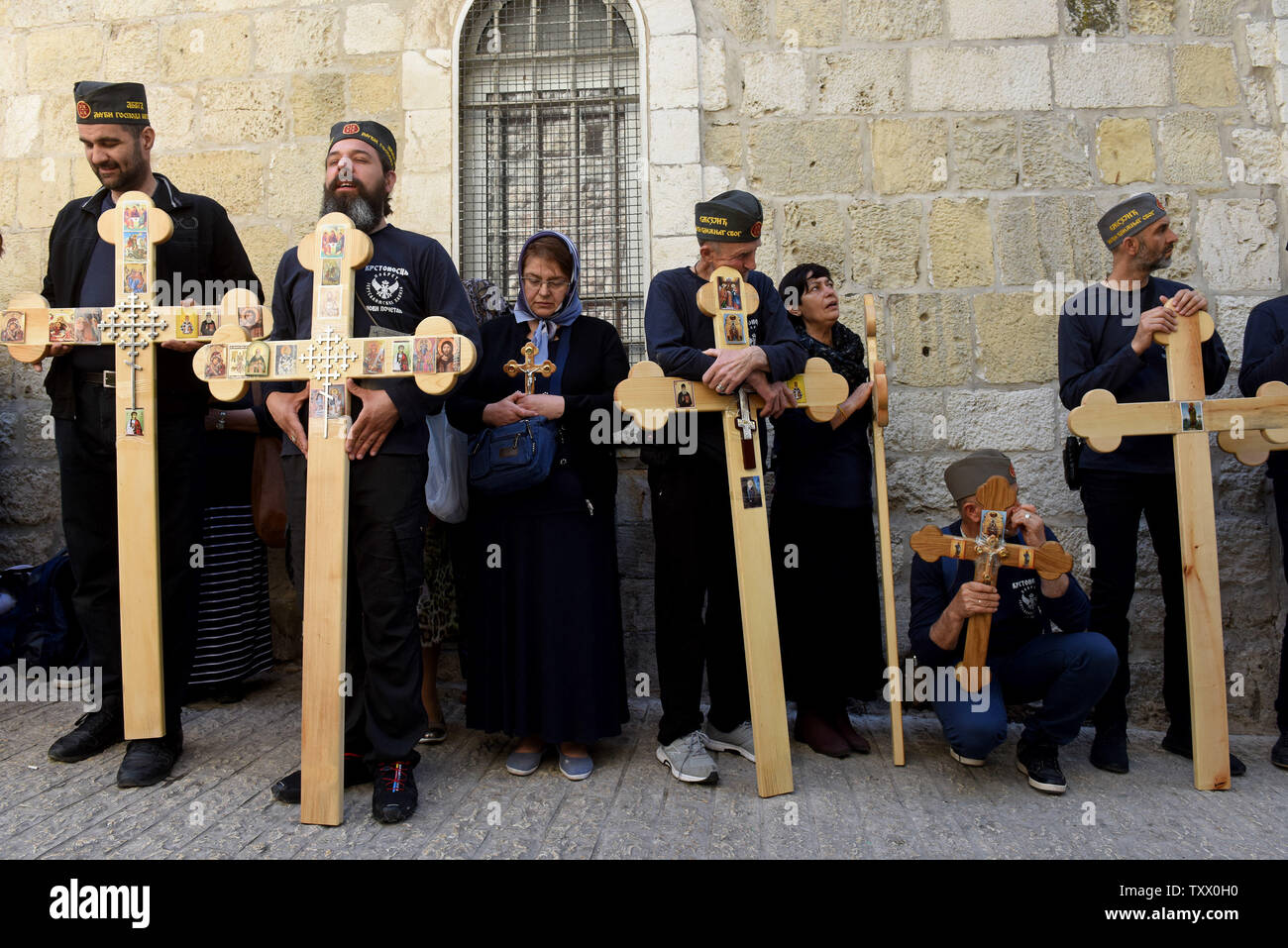 Orthodox Christians from Serbia pray with large wooden crosses before ...