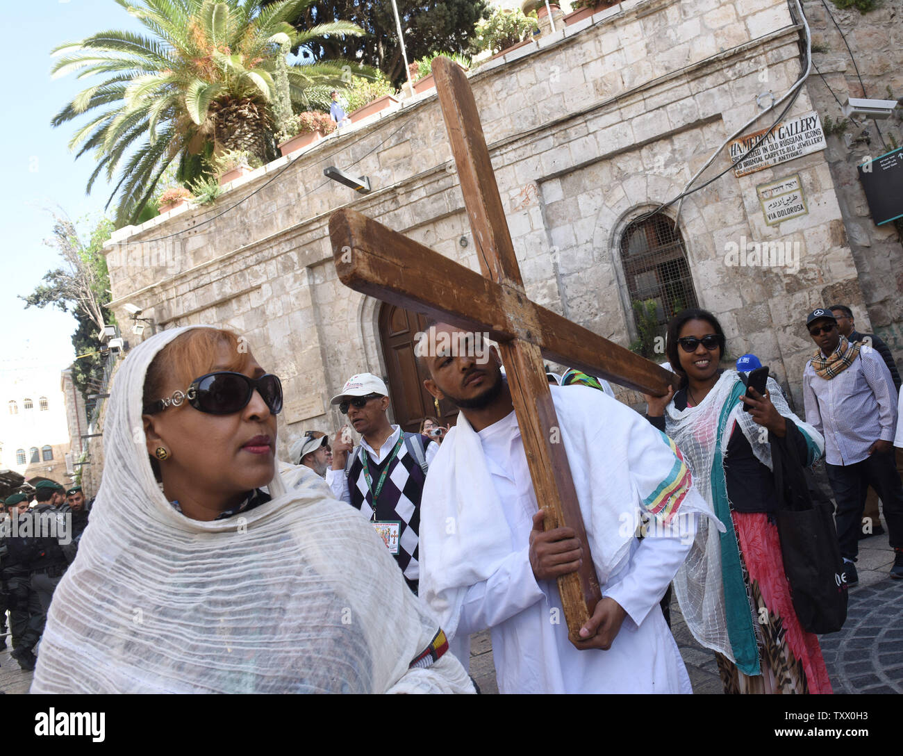 An Ethiopian Orthodox Christian carries a large wooden cross during the ...