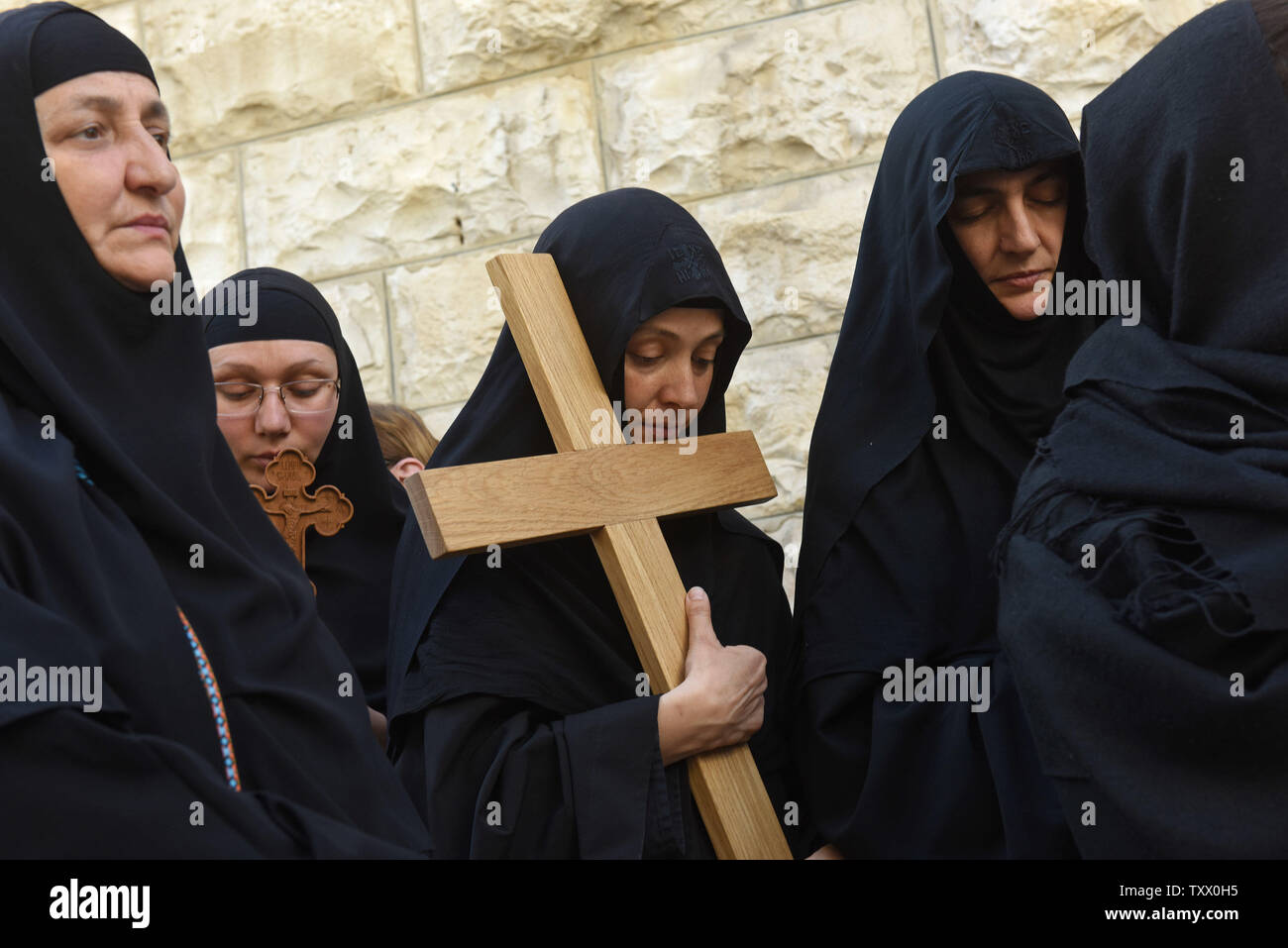 Orthodox nuns from Serbia pray with wooden crosses during the Orthodox ...
