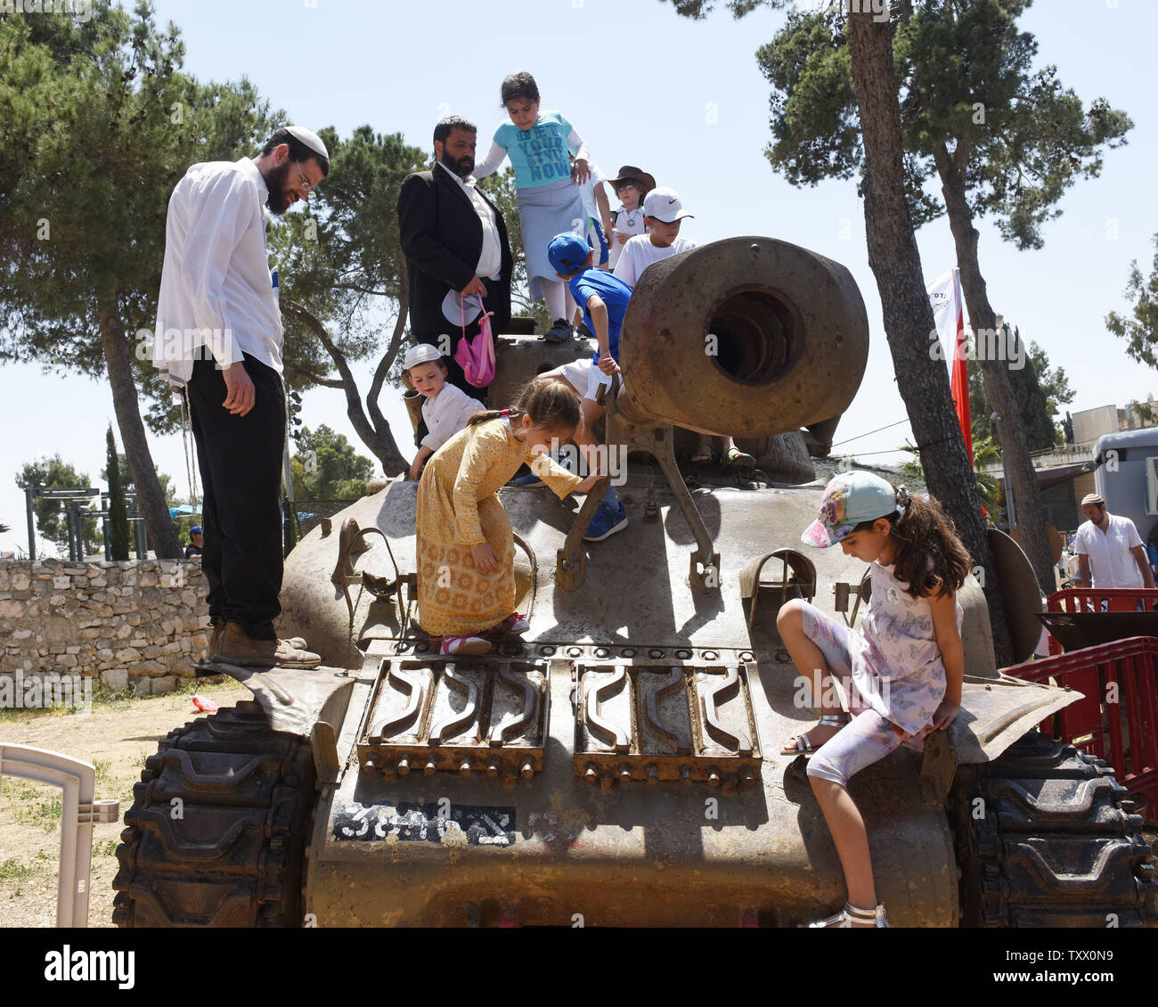 Israelis climb on a tank to celebrate Israel's 70th Independence Day at ...