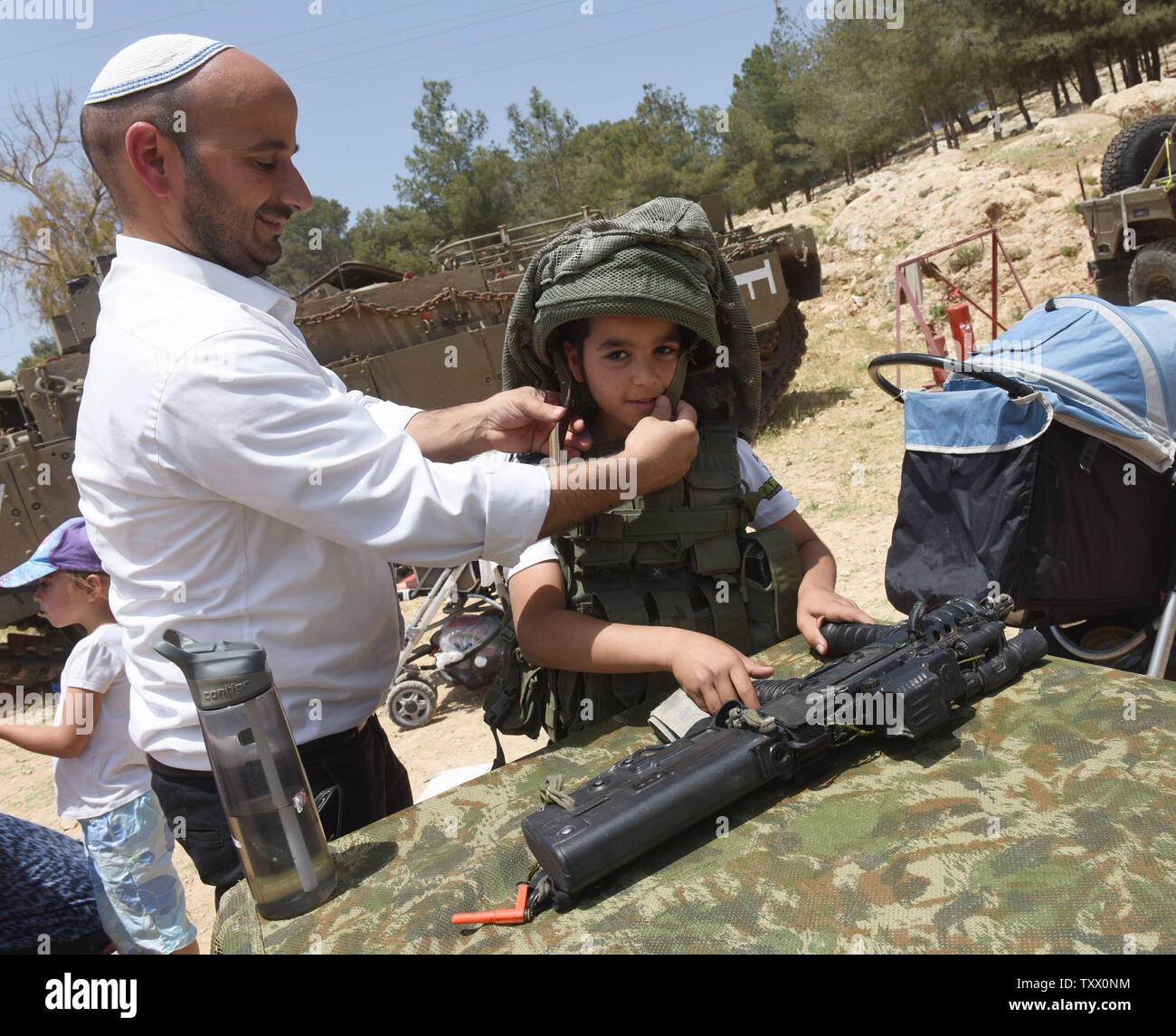 A Jewish boy tries on an army helmet and vest to celebrate Israel's ...