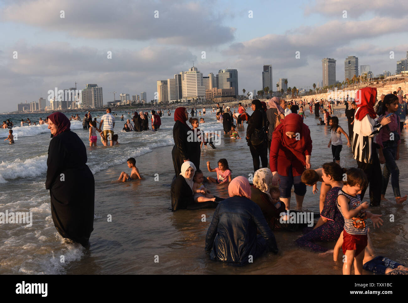 Palestinians enjoy the Mediterranean Sea on a beach in Tel Aviv, Israel ...