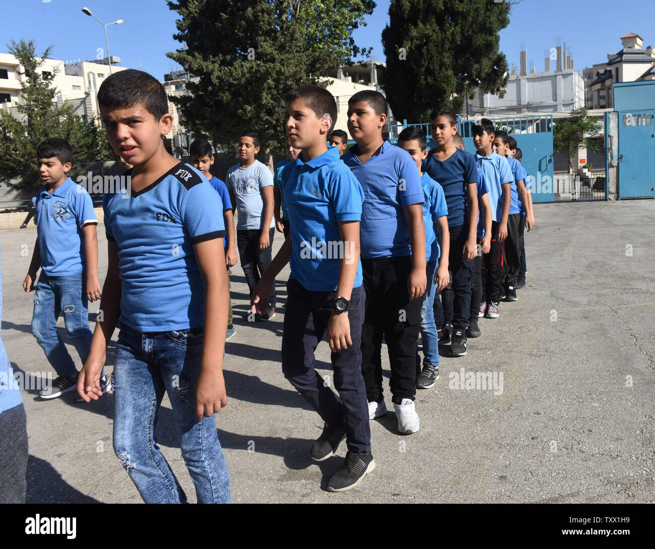 Palestinian boys line up in gym class in the courtyard of the UNRWA ...