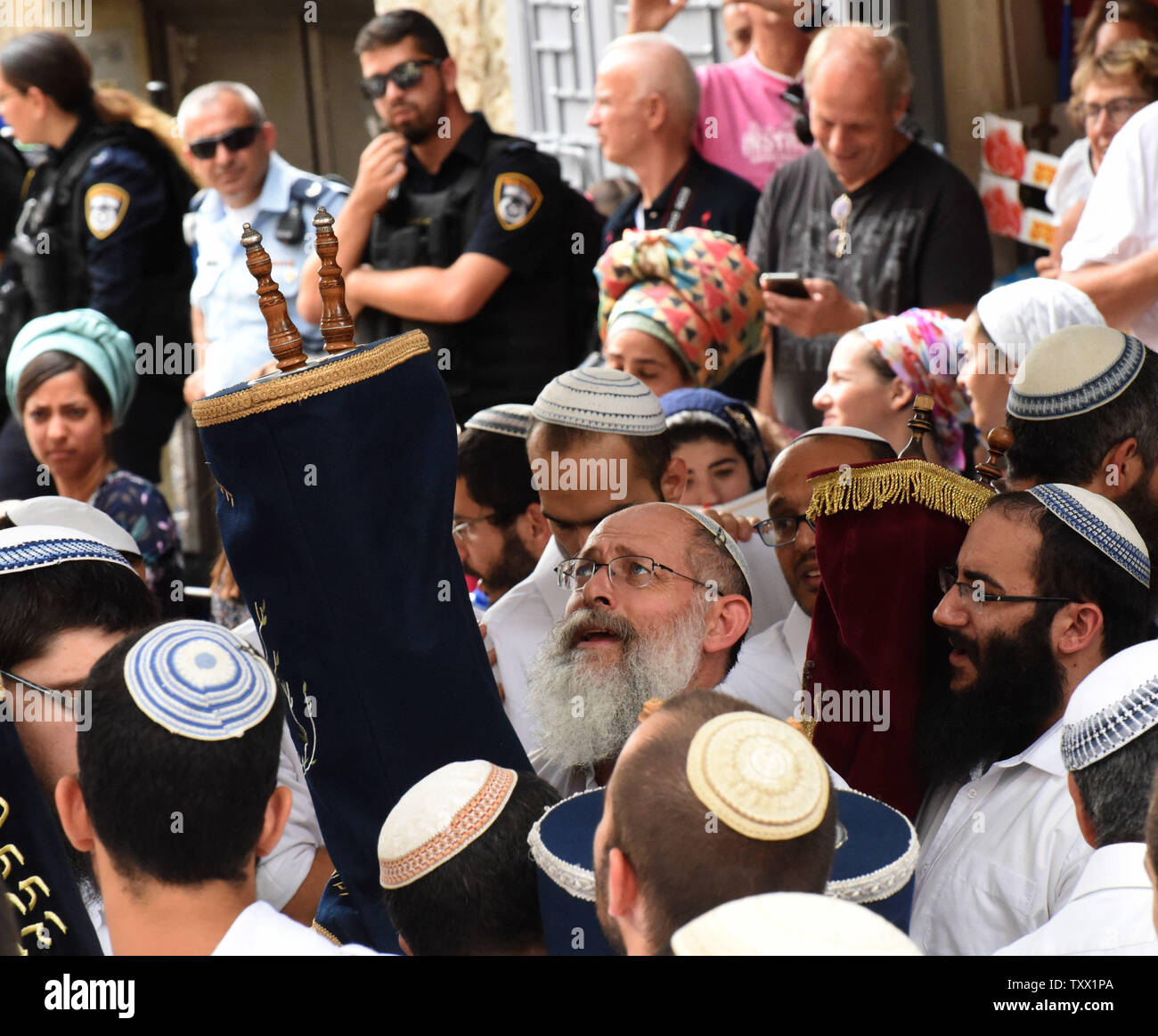 Orthodox Jewish settlers dance and sing with Torah scrolls on Simchat ...