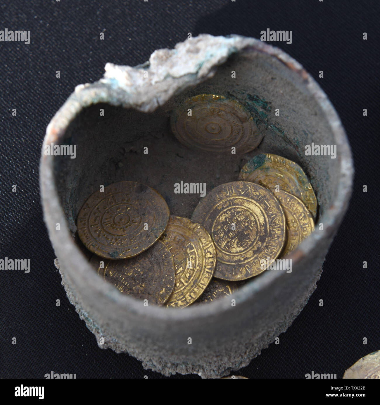 The Israel Antiquities Authority display a bronze pot holding a cache ...