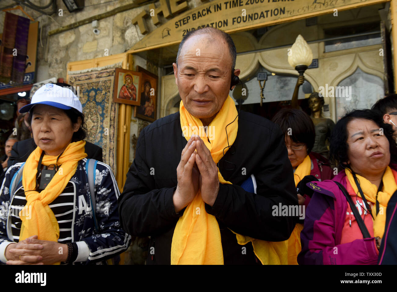 Christian tourists pray on the Via Dolorosa, the Way of the Cross, on ...